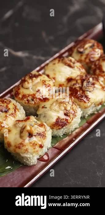 Close-up of delicious Japanese sushi rolls served fresh on a plate in a ...