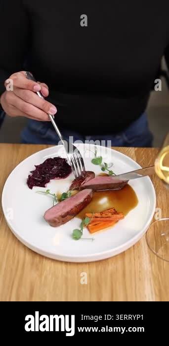 Guests enjoying delicious food in a stylish restaurant. Close-up shots ...