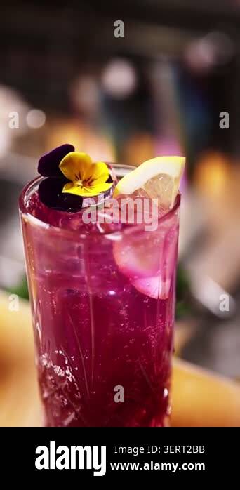 A bartender skillfully prepares a signature cocktail in a moody bar ...