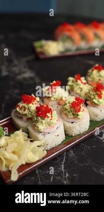 Close-up of delicious Japanese sushi rolls served fresh on a plate in a ...