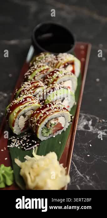Close-up of delicious Japanese sushi rolls served fresh on a plate in a ...