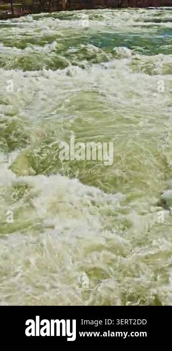 Water rushes quickly through the river, forming waves and ripples. The ...
