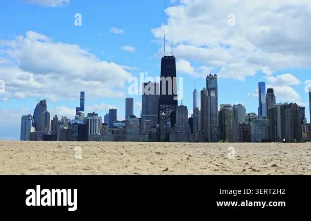 People can be seen enjoying the beach while the city skyline rises in ...