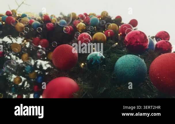 Close-up view of colorful Christmas ornaments decorating a festive tree ...