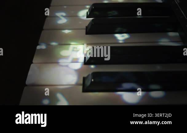 Artistic close-up of piano keys illuminated by soft light and ...