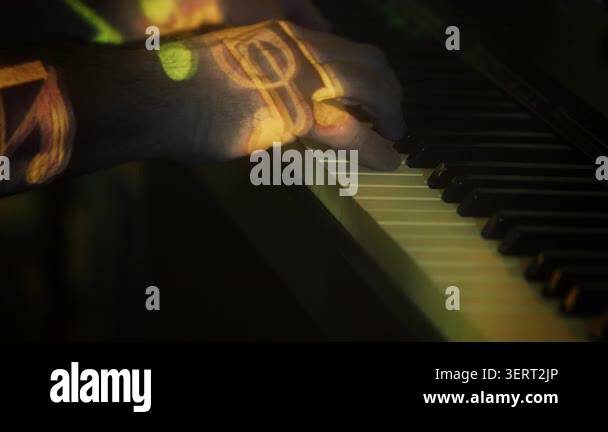 Light music symbols stream onto piano keys while playing, creating a ...