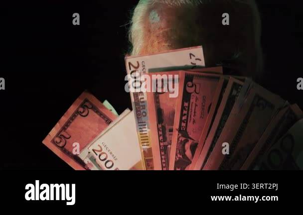 Cinematic storytelling shot of a man enjoying stacks of cash before ...