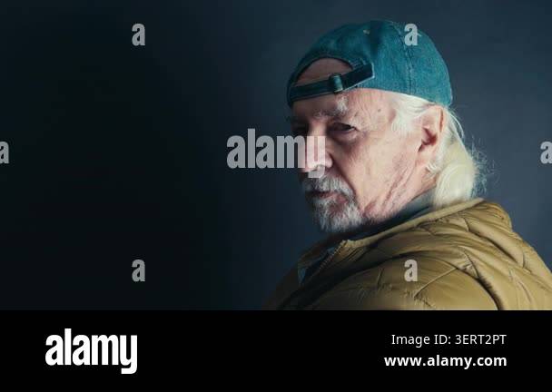 Senior Old Man Wearing a Hat Looks and Smiles Stock Video Footage - Alamy