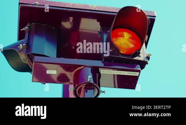 Solar traffic signal with glowing amber warning light at construction ...