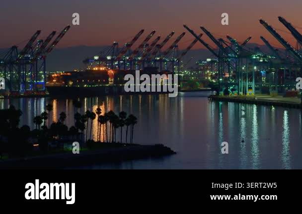San Pedro, CA, USA June 14, 2026: Illuminated port terminal cranes at ...