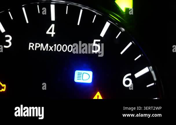 Car tachometer gauge with glowing indicator symbols at night Stock ...
