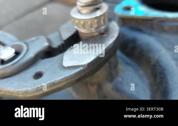 Close-up of water pump pliers loosening a rusty metal nut Stock Video ...