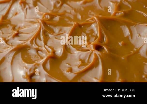 Boiled condensed milk texture or dulce de leche background Stock Video ...