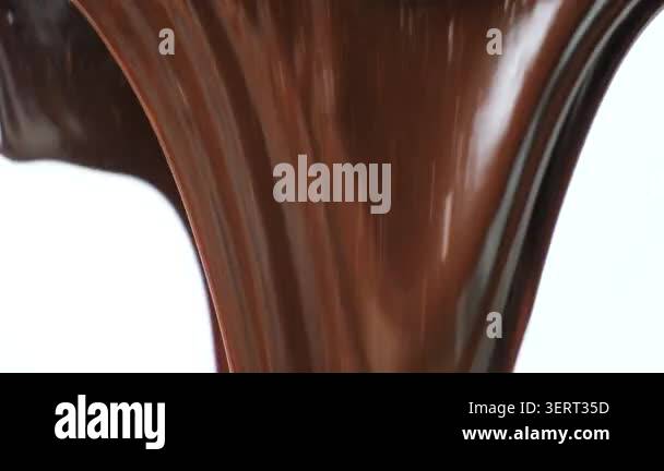 Chocolate sauce flowing and dripping on white macro background Stock ...