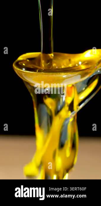 Organic Vegetable Unrefined Oil Pour into Spoon. Slow Motion Macro ...