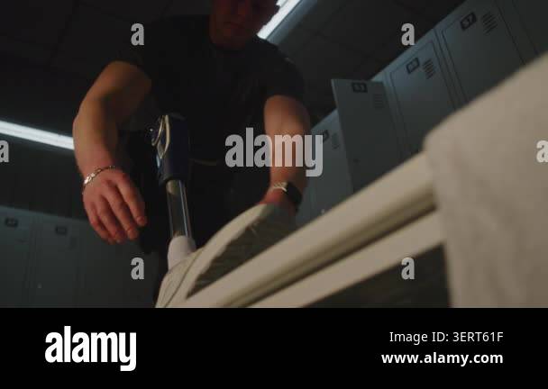 Close Up of Young Man With Leg Disability Leaning Over Bench to Tie ...