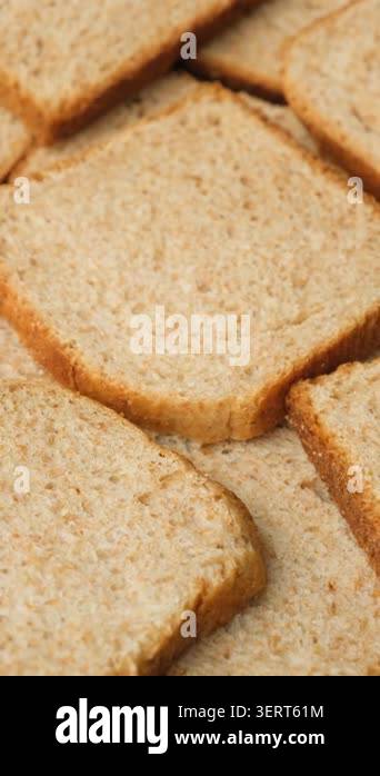 Close-up of a stack of crispy whole wheat toast bread slices rotating ...
