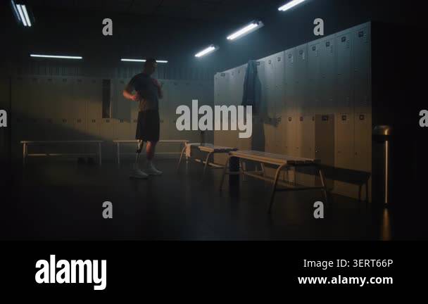 Young Man with Prosthetic Leg Performs Warm Up and Stretches in Sunlit ...