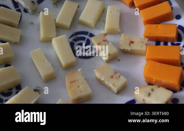 Top view panning shot of a ceramic plate filled with small cubes of ...