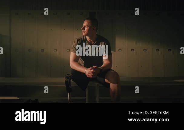 Athlete with Bionic Leg Sitting in Beam of Light. Man Transitions From ...