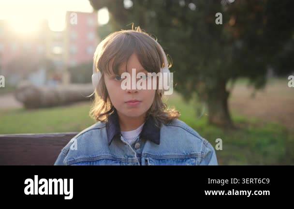 Kid on the phone music concept with young child wearing white ...