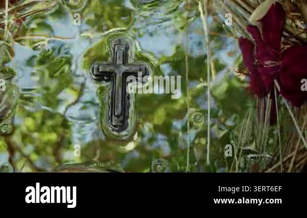 Christian Symbol Cross On Holy Water and The Reflection of Tree Leaves ...
