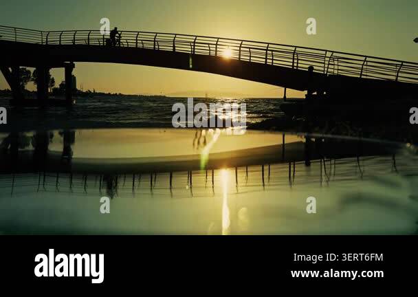 Sport Cyclist Crossing a Bridge Over the Sea at Sunset Stock Video ...