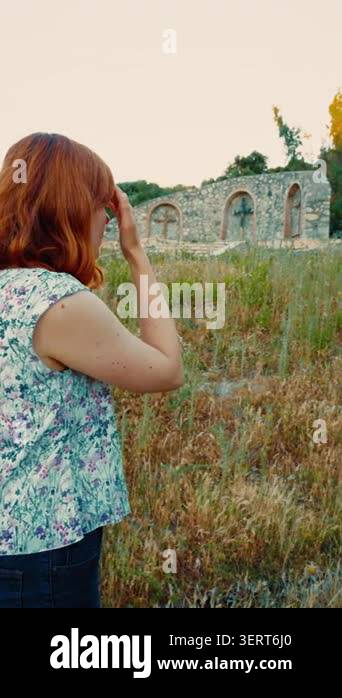 Woman prays in front of Italian Christian religious crucifix Calvary ...