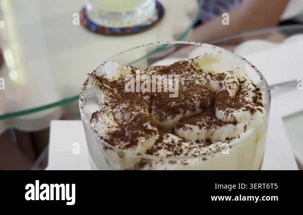 Sprinkling Cocoa on Creamy Delicious Dessert in a Glass Cup Stock Video ...