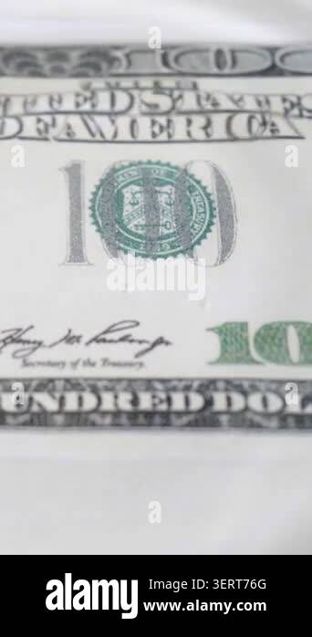 Drops of water and ripples with a hundred dollar bill growing economy ...