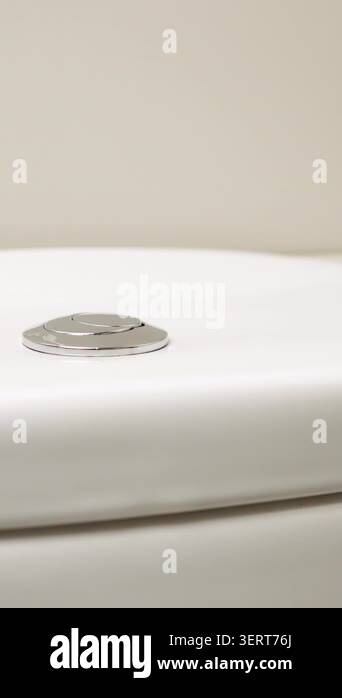 Male hand pushing a button to flush a close tool a bathroom toilet ...