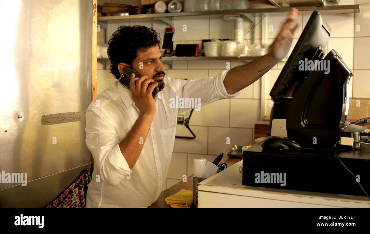 Indian restaurant waiter taking phone order Stock Video Footage - Alamy