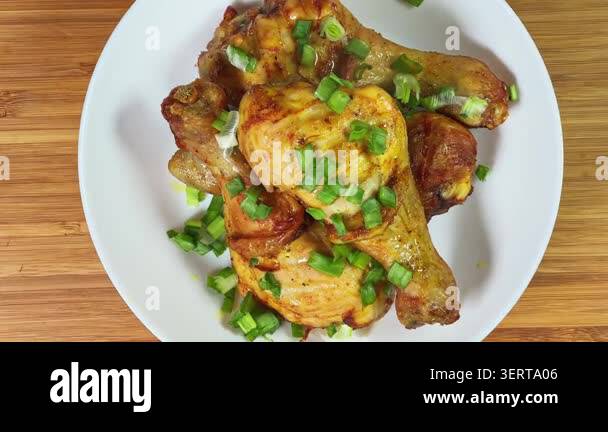 Grilled chicken drumsticks on a plate on a wooden surface Stock Video ...