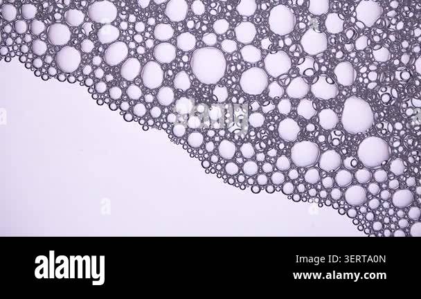 Soap suds creating abstract pattern with varying transparent bubbles on ...