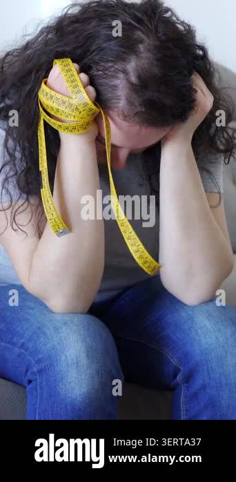 Sad woman obsessed with diet complaining sitting in couch at home and ...