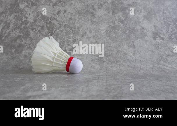 Shuttlecock falling on abstract gray background Stock Video Footage - Alamy