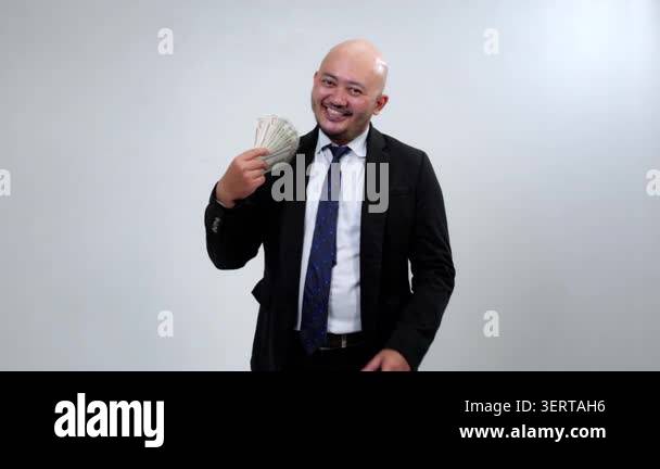 Successful Businessman Smiling and Displaying Cash Fan Toward the ...