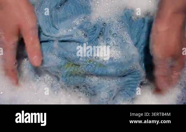Washing dirty clothes with stains, hand wash, bowl with detergent, dirt ...