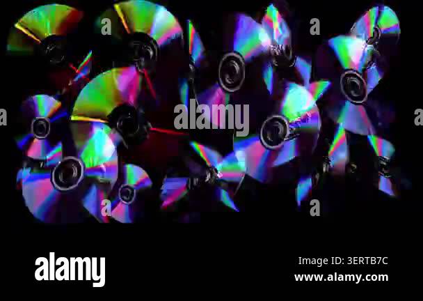 a rotating CD and DVD discs showcasing vibrant rainbow-like colors ...