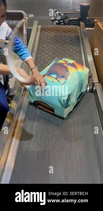 SAMUI THAILAND JUNE 14 2026: Boarding suitcase on conveyor belt for ...