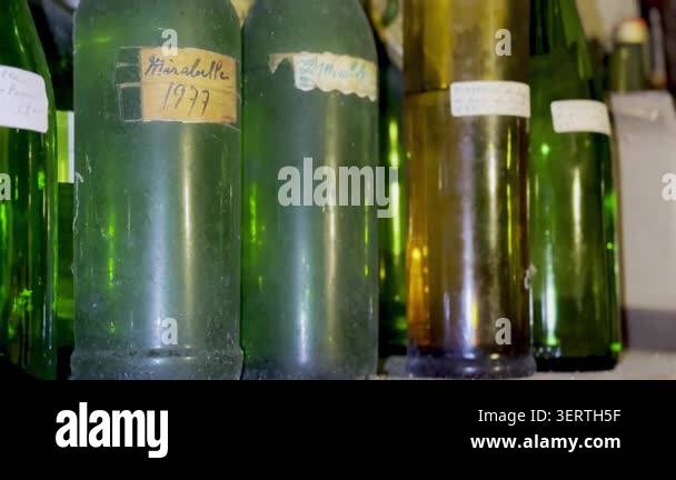 Old dusty bottles of homemade Mirabelle plum brandy with handwritten ...