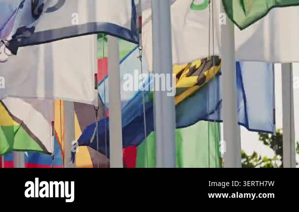 Flags of different countries are seen moving in the breeze in a public ...