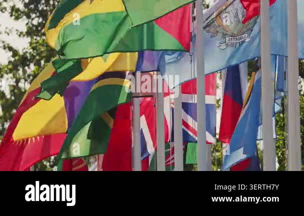 People gather in a park to celebrate diversity as flags from various ...