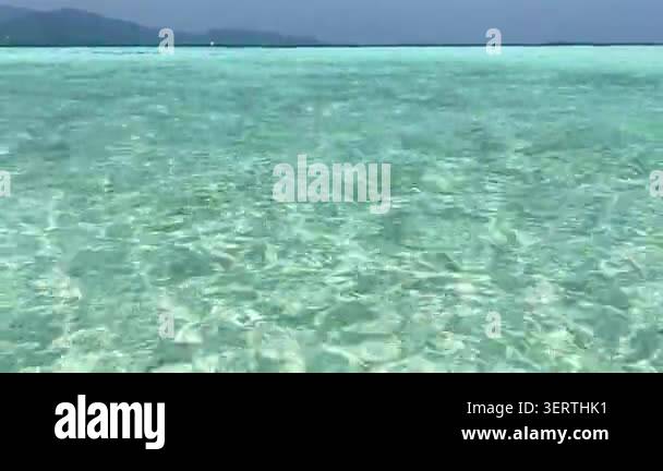Clear turquoise tropical ocean water with distant mountains Stock Video ...
