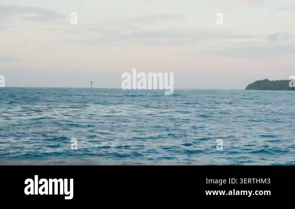 Calm ocean horizon with distant island and navigation buoys Stock Video ...
