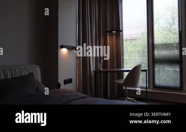 Calm contemporary bedroom with a bed in the foreground, floor to ...