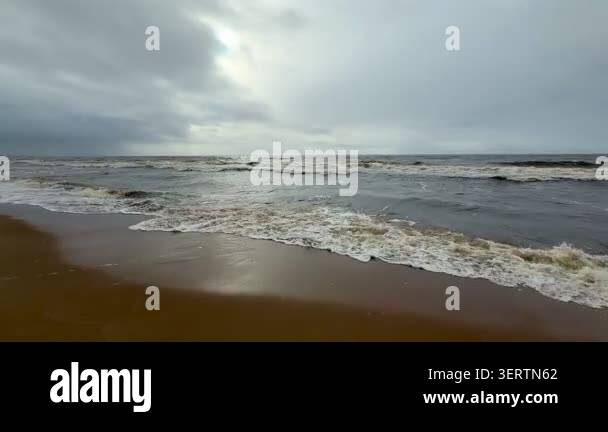 baltic sea coast, a cloudy and a glowing waves, glowing waves, splashes ...