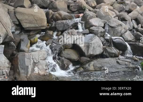 A beautiful fast flowing waterfall. Water cascades down from a steep ...