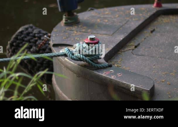 Boat tied with a rope on moorings medium panning slow motion shot ...