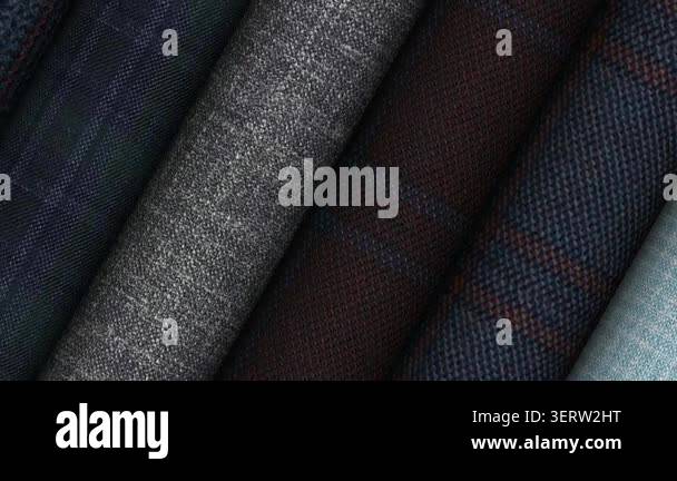 Elegant Italian fabric collections presented as rotating rolls ...